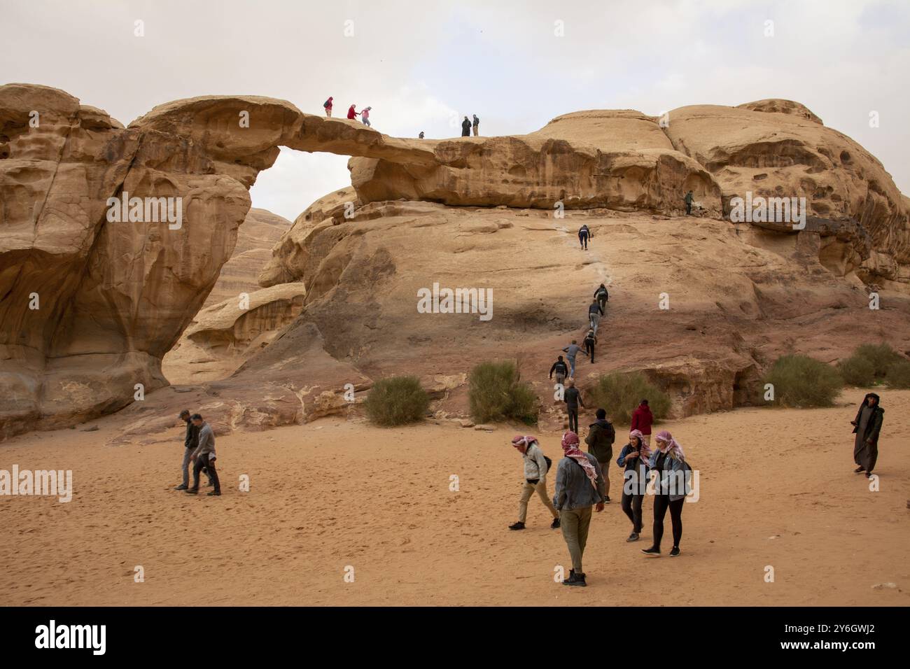 Wadi Rum, Jordan, March 2020: People, tourists, climbing the Um Frouth ...