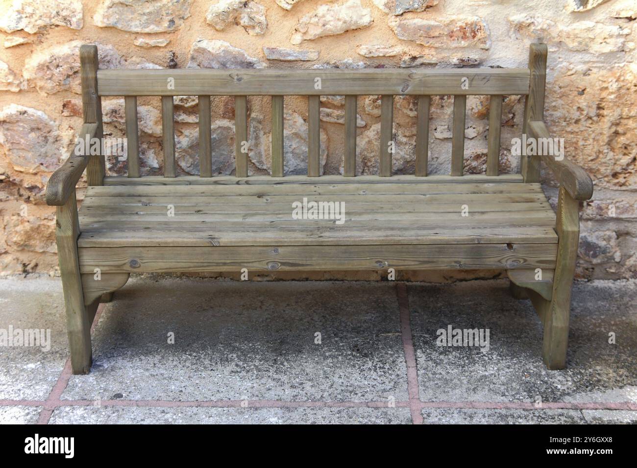 Old wooden weathered bench near stone wall Stock Photo - Alamy