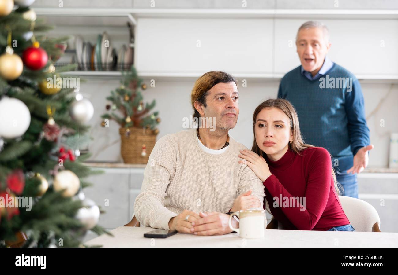 Sad couple listens to their elderly father scream and swear while ...
