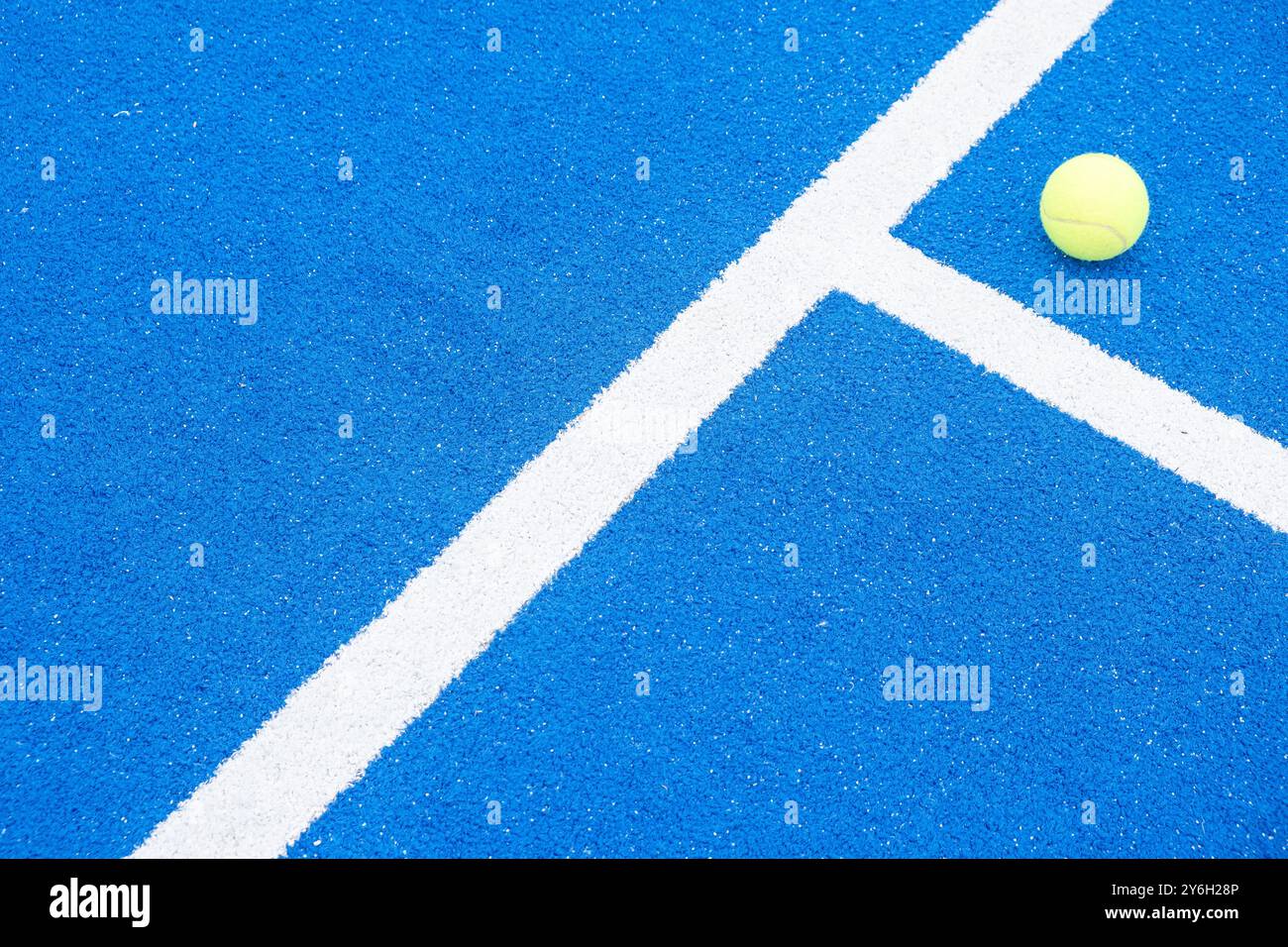 a ball near the lines in a blue padel tennis court Stock Photo - Alamy