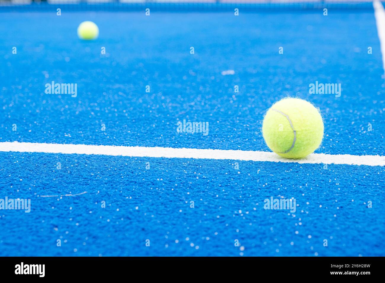 two balls near the lines in a blue turf padel tennis court Stock Photo ...