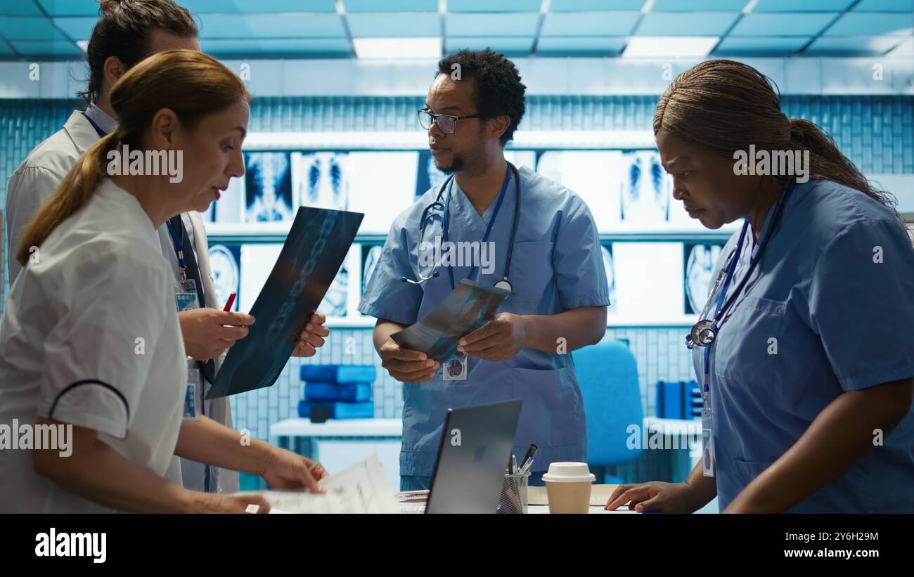 Physicians and radiologists analyzing x ray scans to create an effective treatment plan. Medics ...