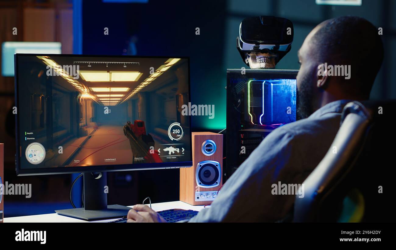 Man arriving at home to play videogames on gaming PC at computer desk ...