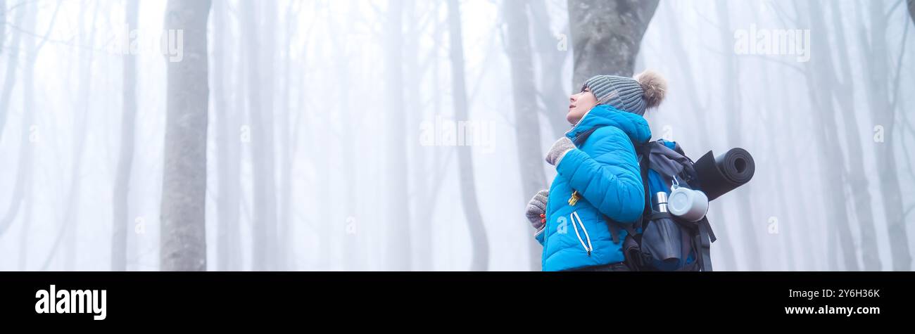 Side view of a hiker woman hiking in the mountains breathing fresh air ...