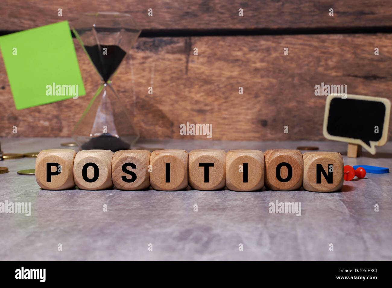 word position made from wooden gray letters lies on a blue background ...