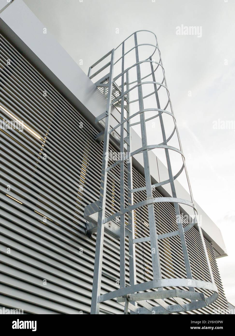 Metal Ladder on Modern Building with Horizontal Panels Stock Photo - Alamy