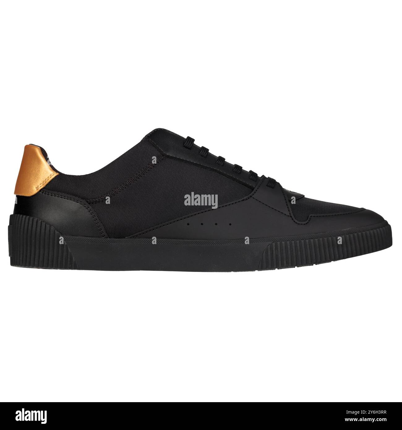 Black sneaker with gold accent Stock Photo - Alamy