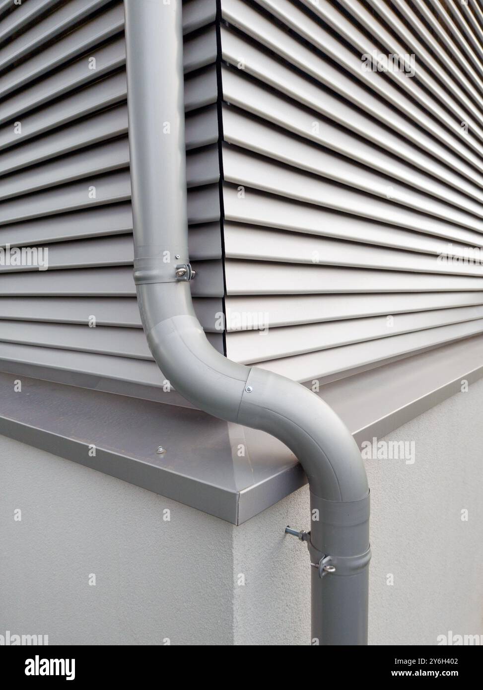 Modern Rainwater Downspout on Building Corner Stock Photo - Alamy