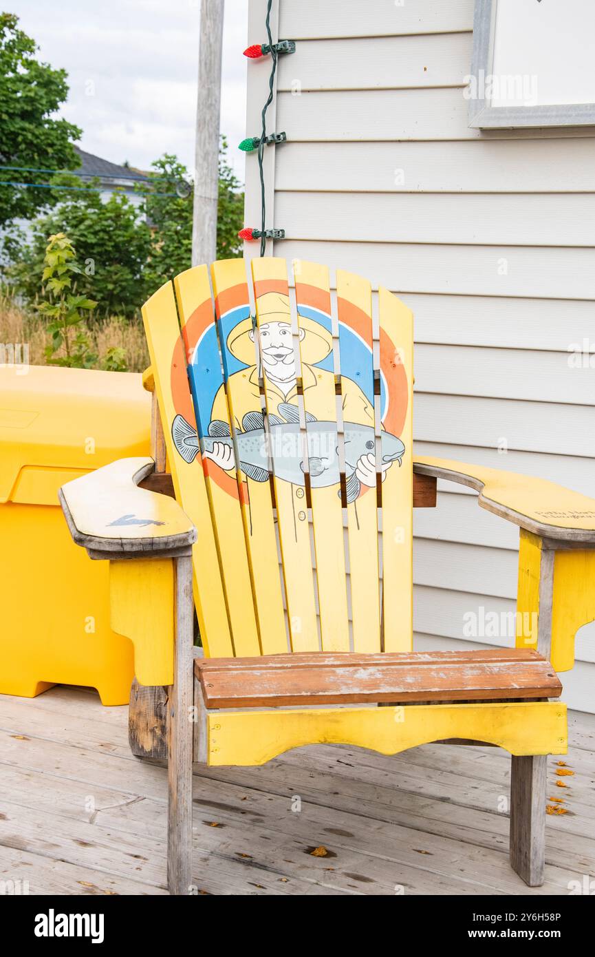 Mural of a fisherman catching a cod fish on an Adirondack chair in ...
