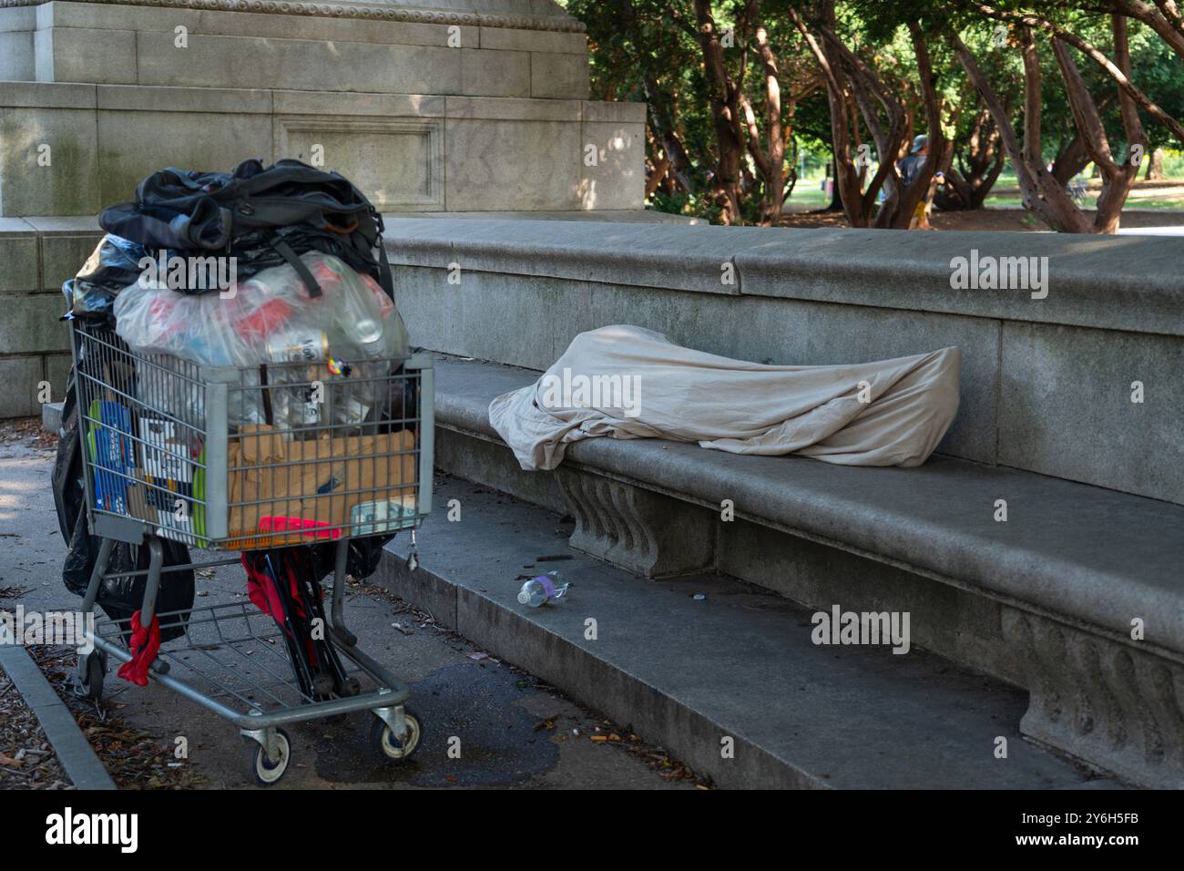 Homeless man with his shopping cart filled filled with cans for cashing ...