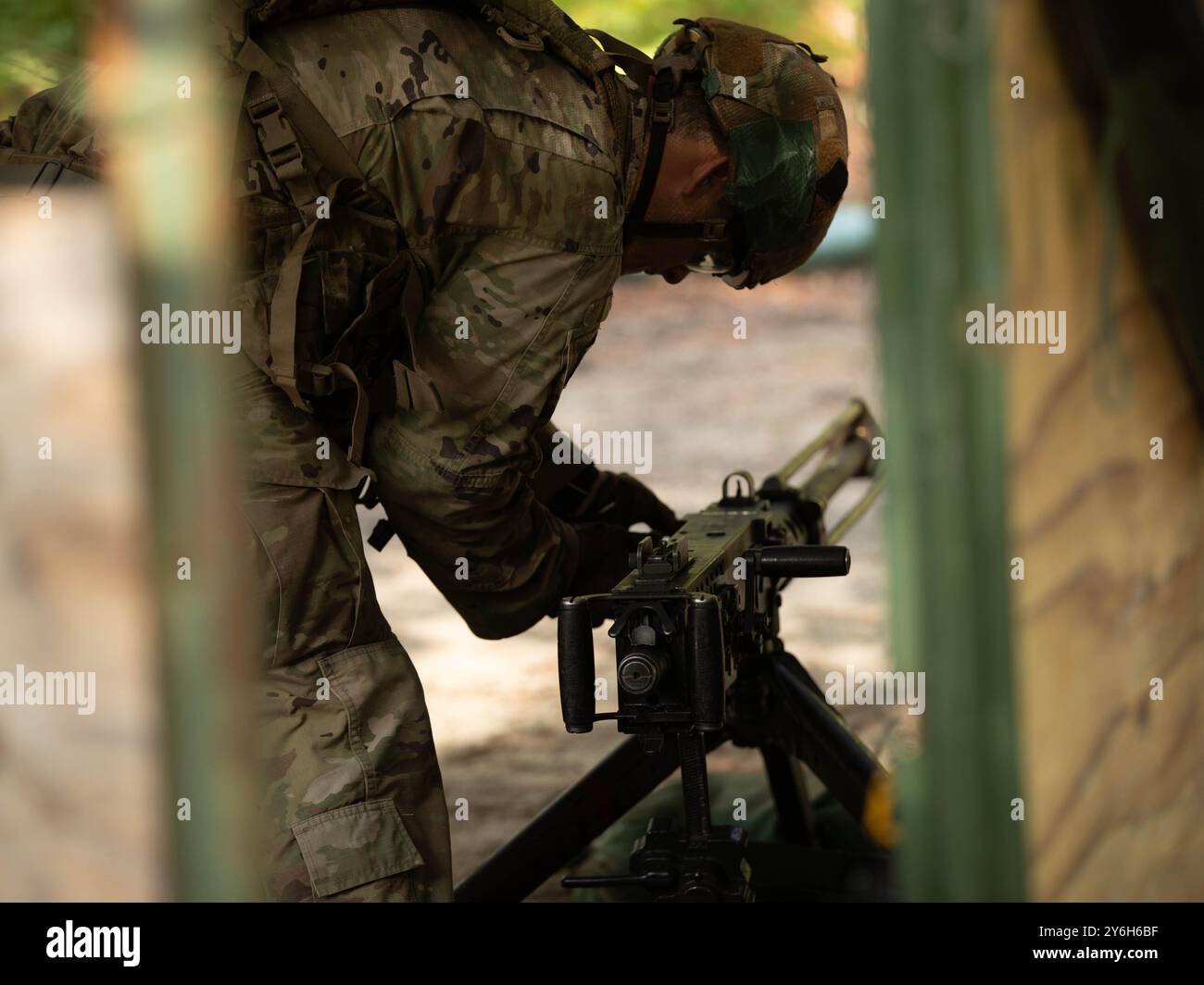 A Paratrooper assigned to the 82nd Airborne Division adjusts an M2 .50 ...