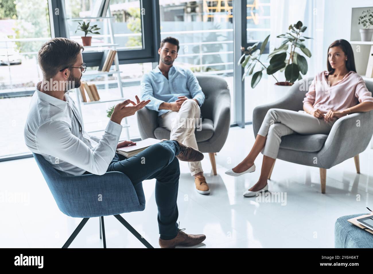 You should trust each other. Young married couple talking while sitting ...