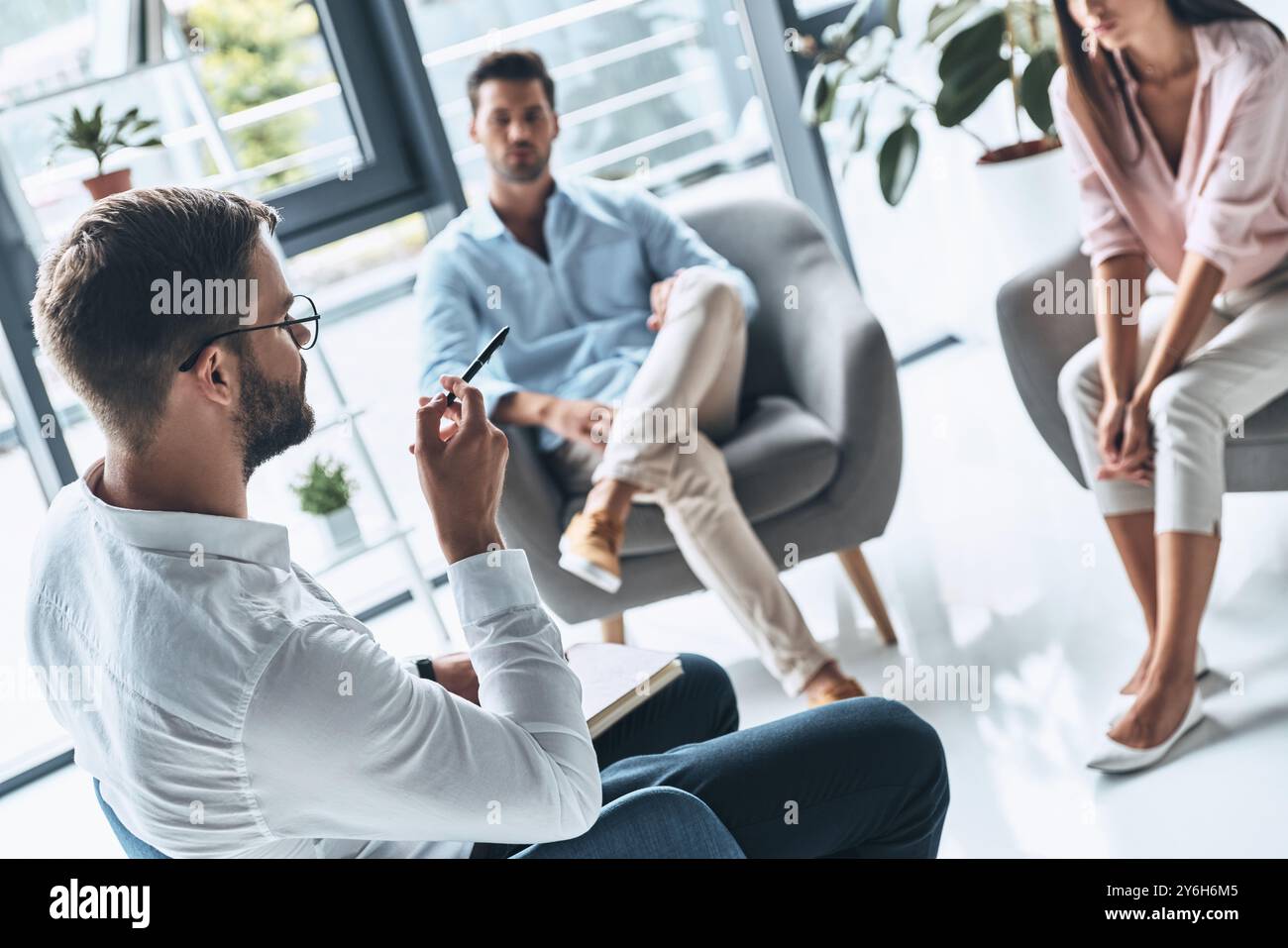 Be patient. Young married couple listening to psychologist while ...