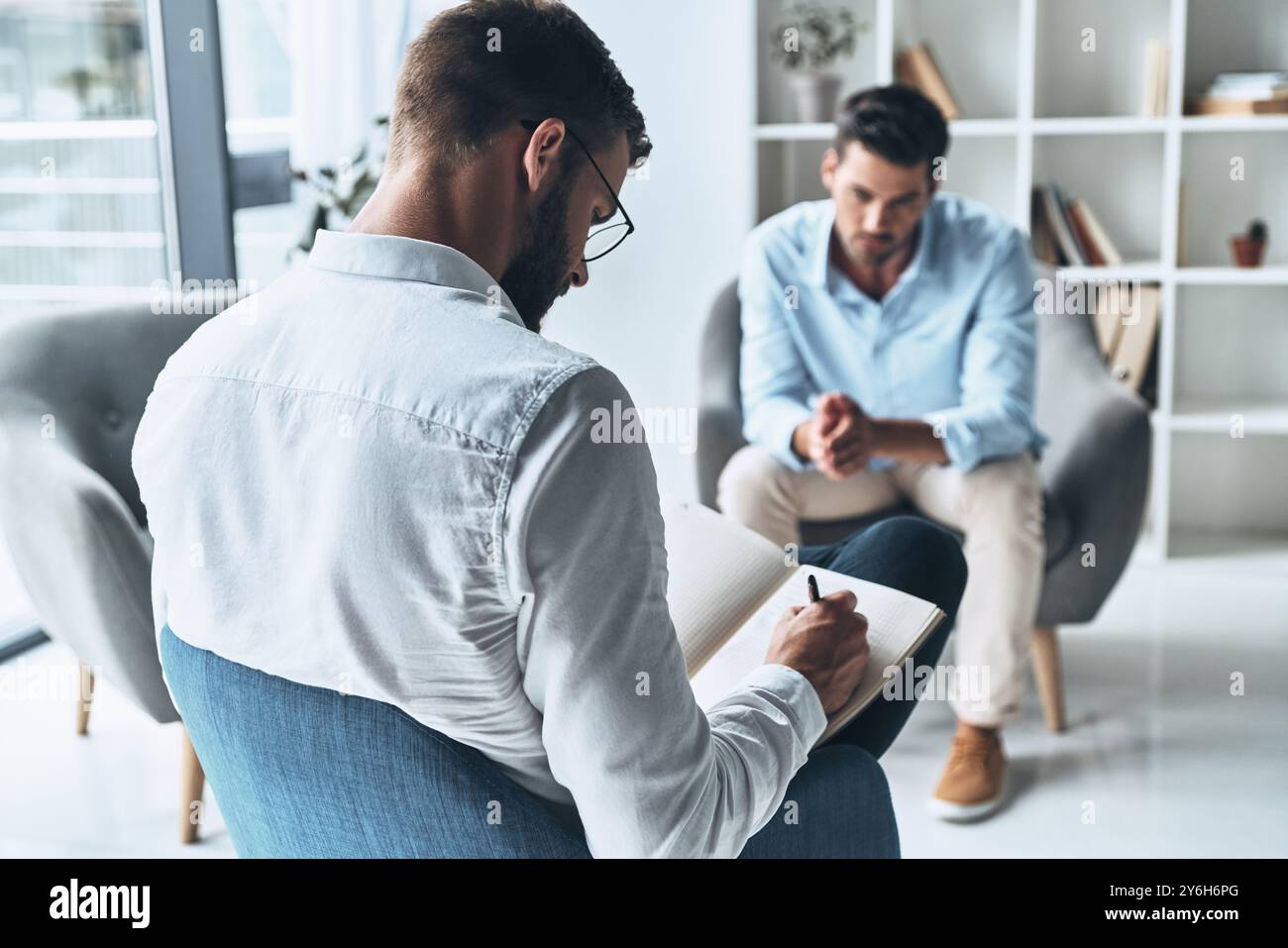 Facing social difficulties. Young frustrated man solving his mental problems while having ...