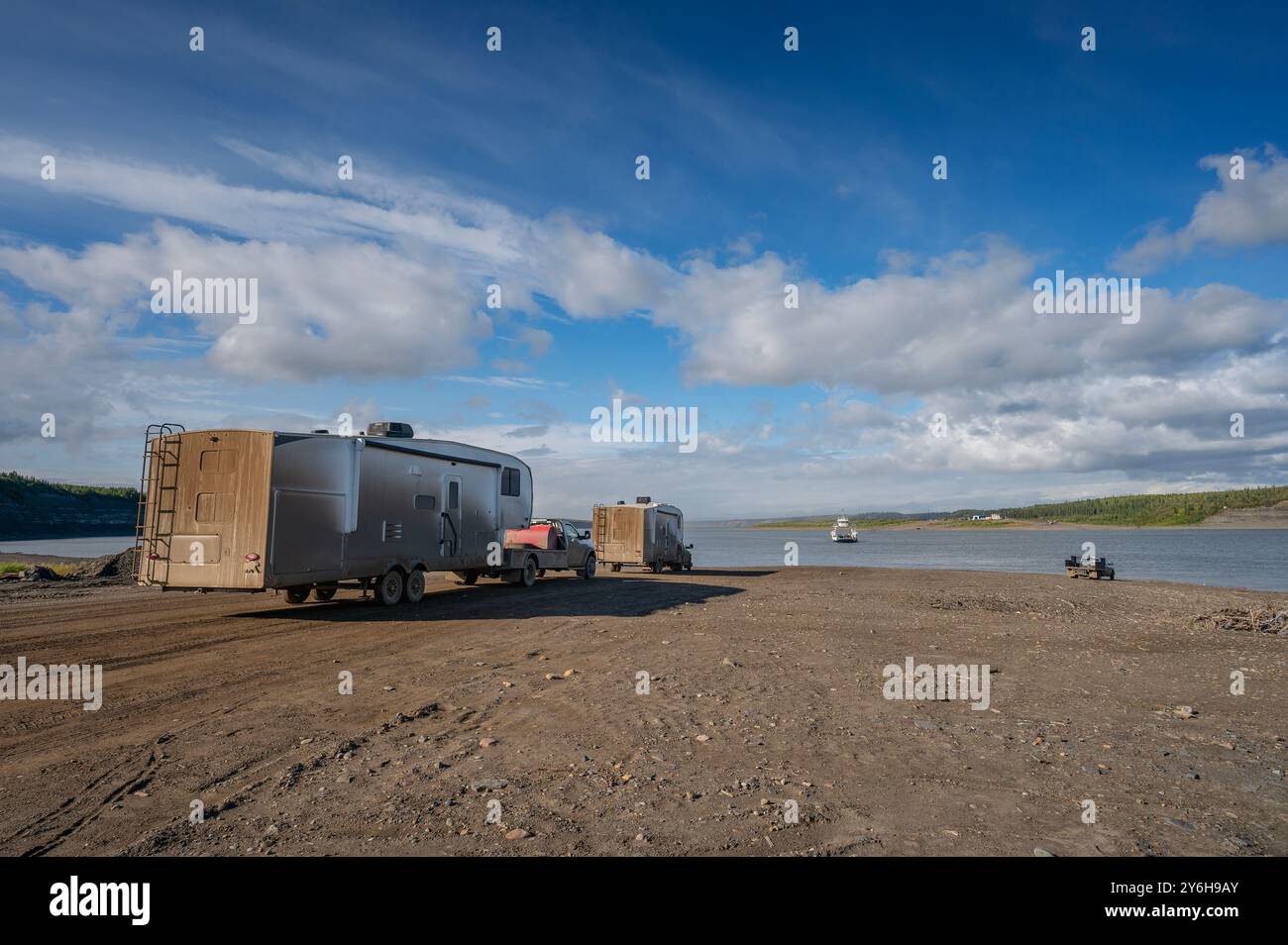 Mud covered motor homes wait for the Mackenzie River ferry crossing on ...