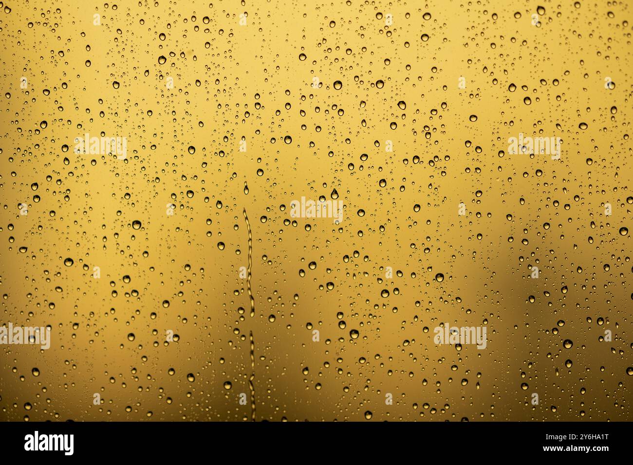 Abstract view of Rain drops on window with warm background Stock Photo ...
