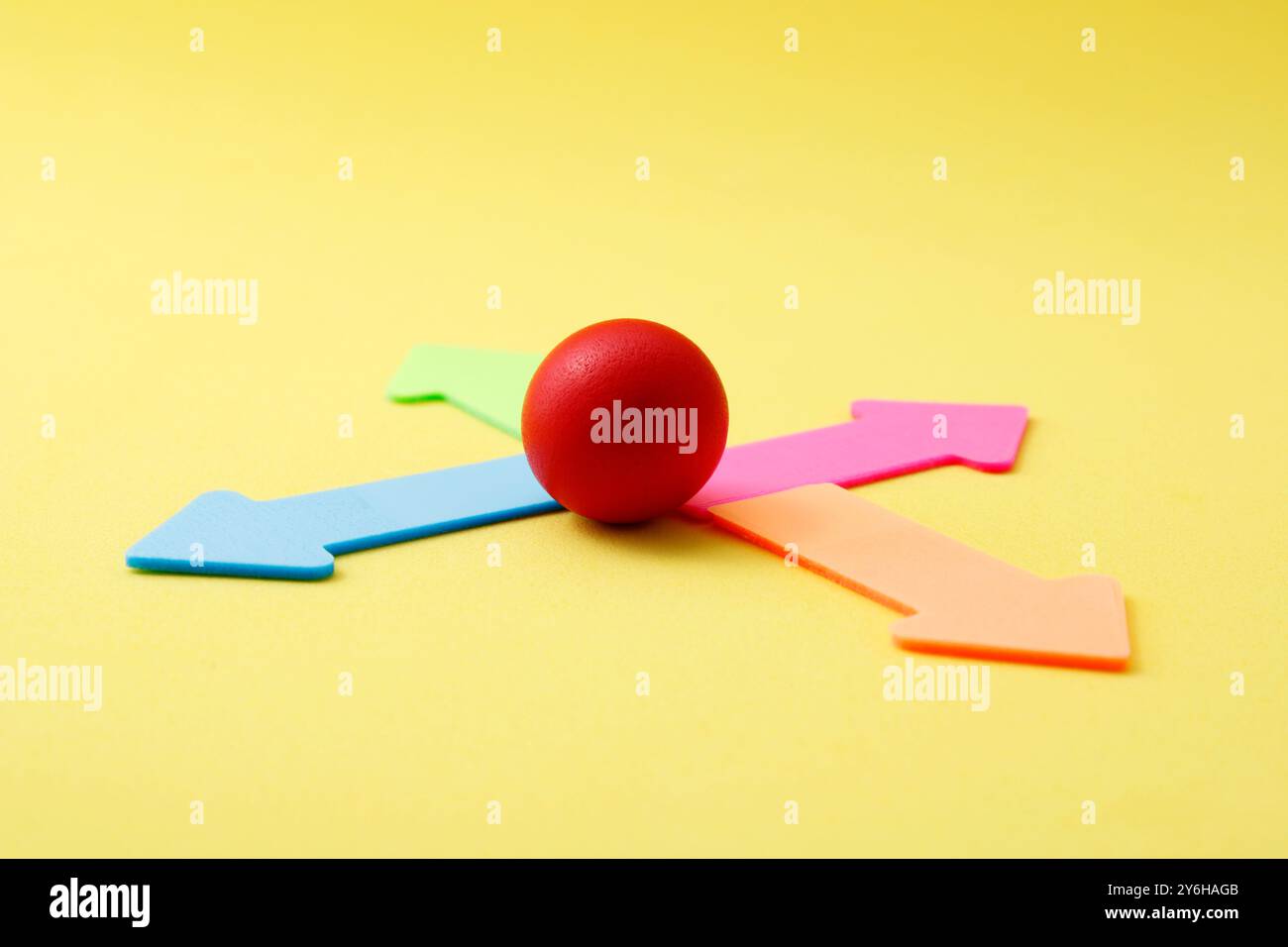 Sphere next to arrows indicating various directions Stock Photo - Alamy