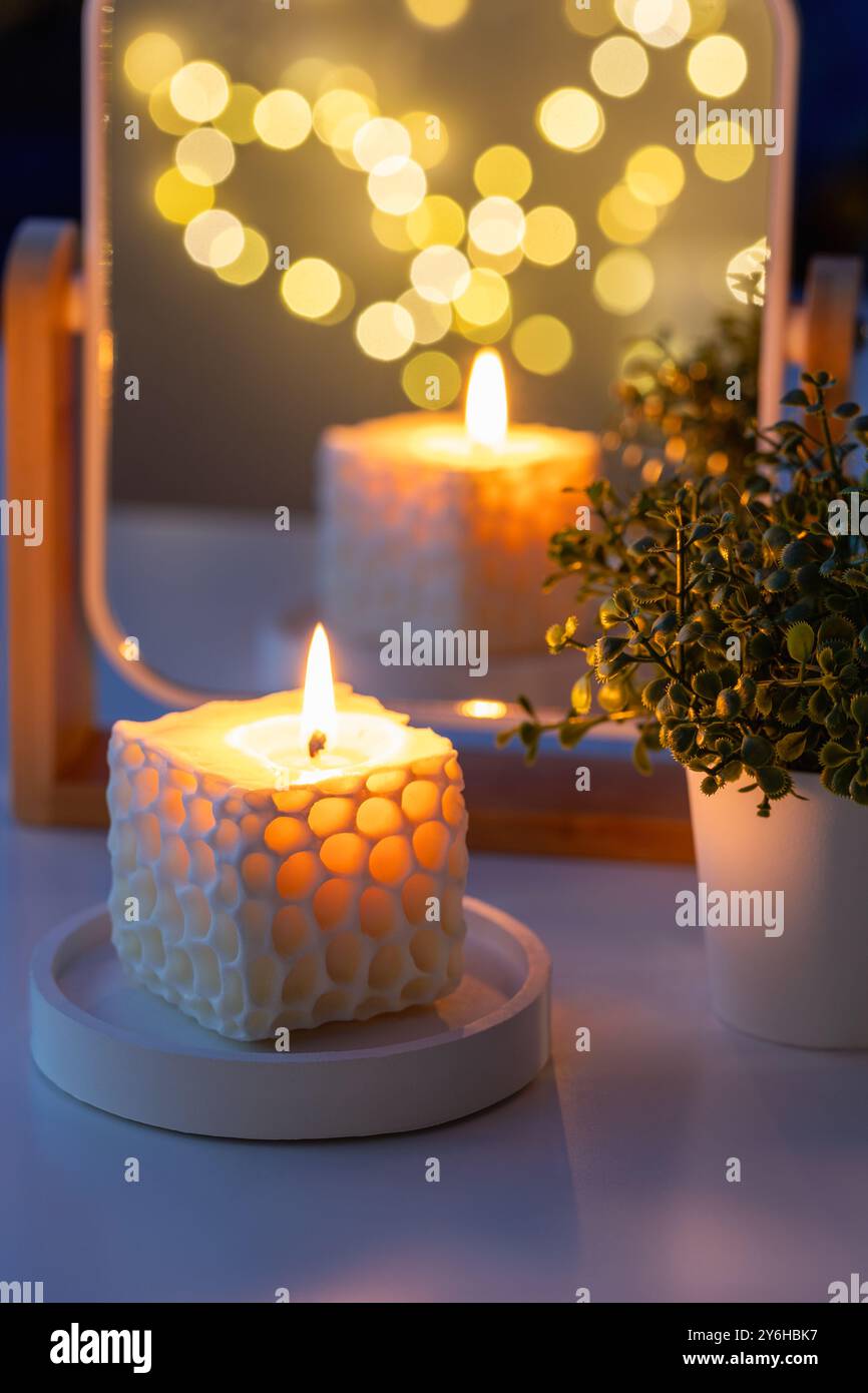 Soy wax candle in front of a mirror. Reflection of candlelight and cozy ...