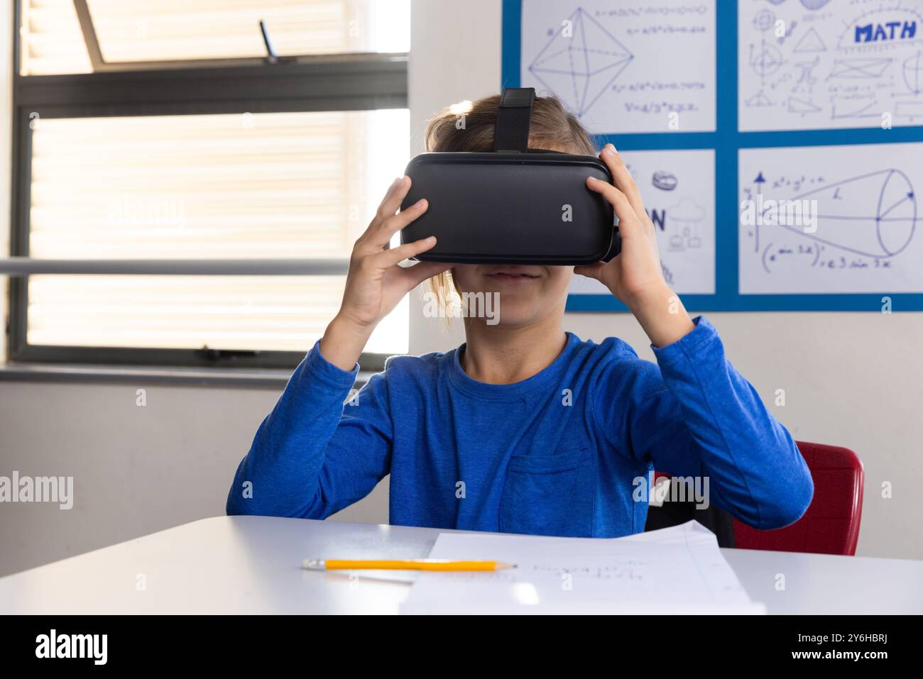 Using VR headset, boy exploring virtual reality in school classroom Stock Photo - Alamy