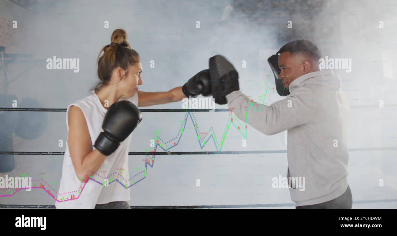 Boxing training with financial graph image over athletes in smoky gym ...