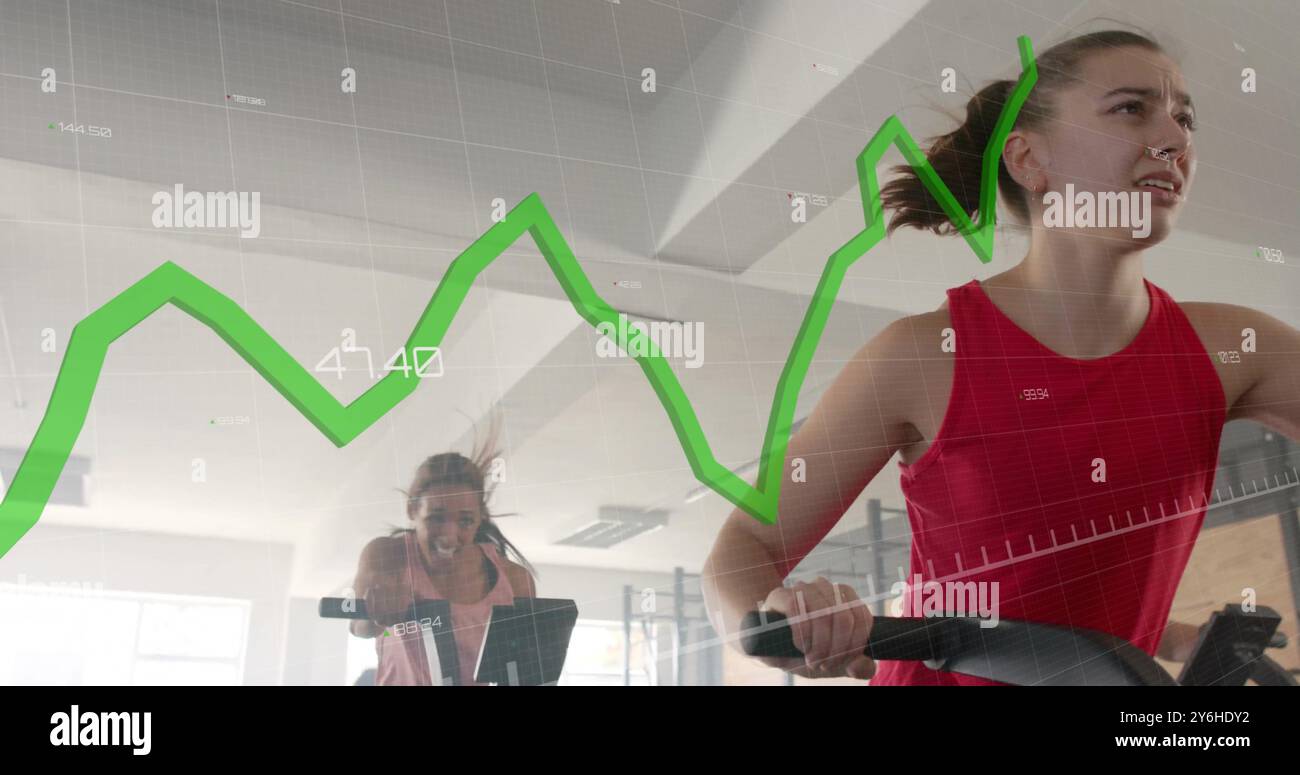 Green financial graph image over people exercising on stationary bikes ...