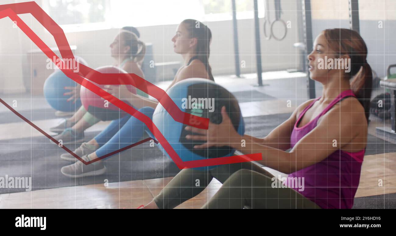 Women exercising with medicine balls, fitness image over gym background ...