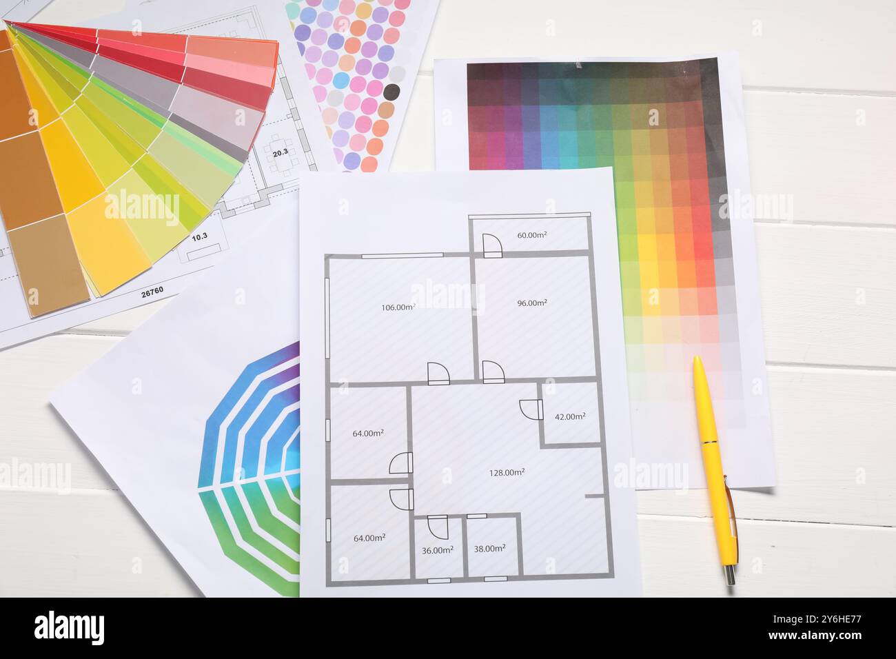 Designer's workplace with color palettes, floor plans and pen on white ...
