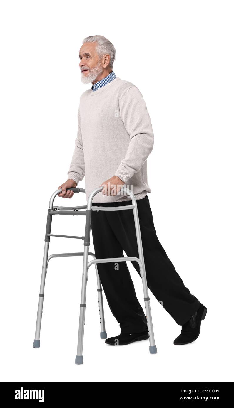 Senior man using walking frame on white background Stock Photo - Alamy