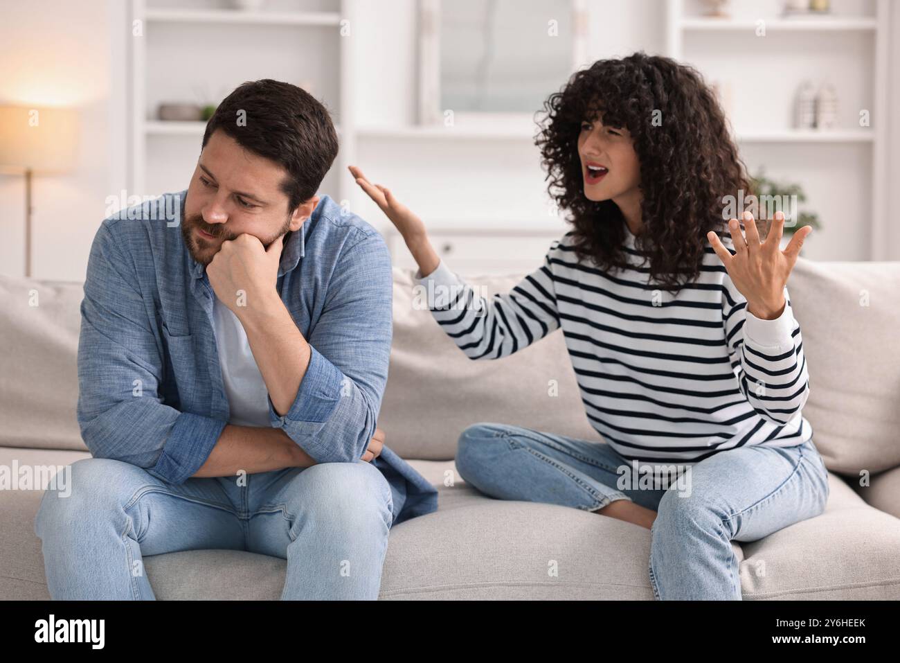 Emotional couple arguing on sofa at home. Relationship problems Stock ...