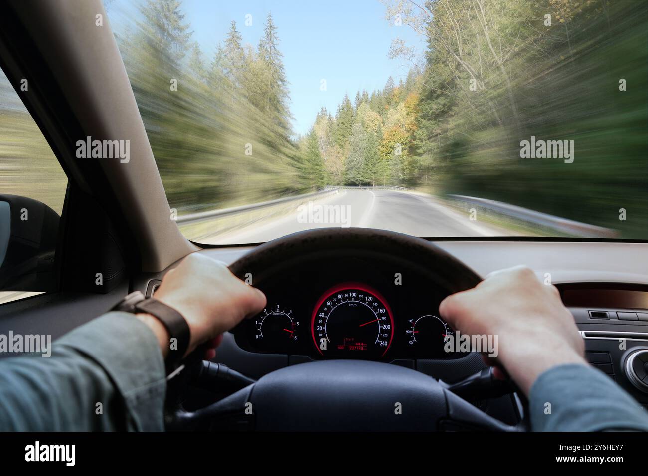 Man driving car on empty road at high speed, first-person view. Motion ...