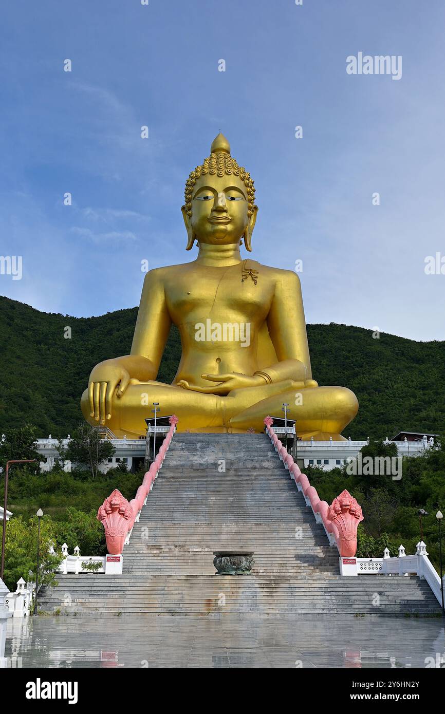 Steps leading to gigantic golden seated Buddha in earth-touching ...