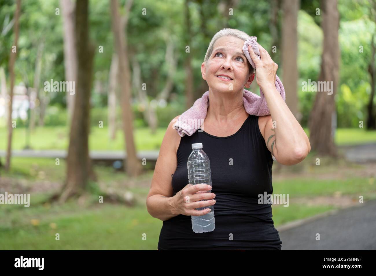 Healthy Aging: Elderly Woman Enjoying Refreshing Jog with Hydration in ...