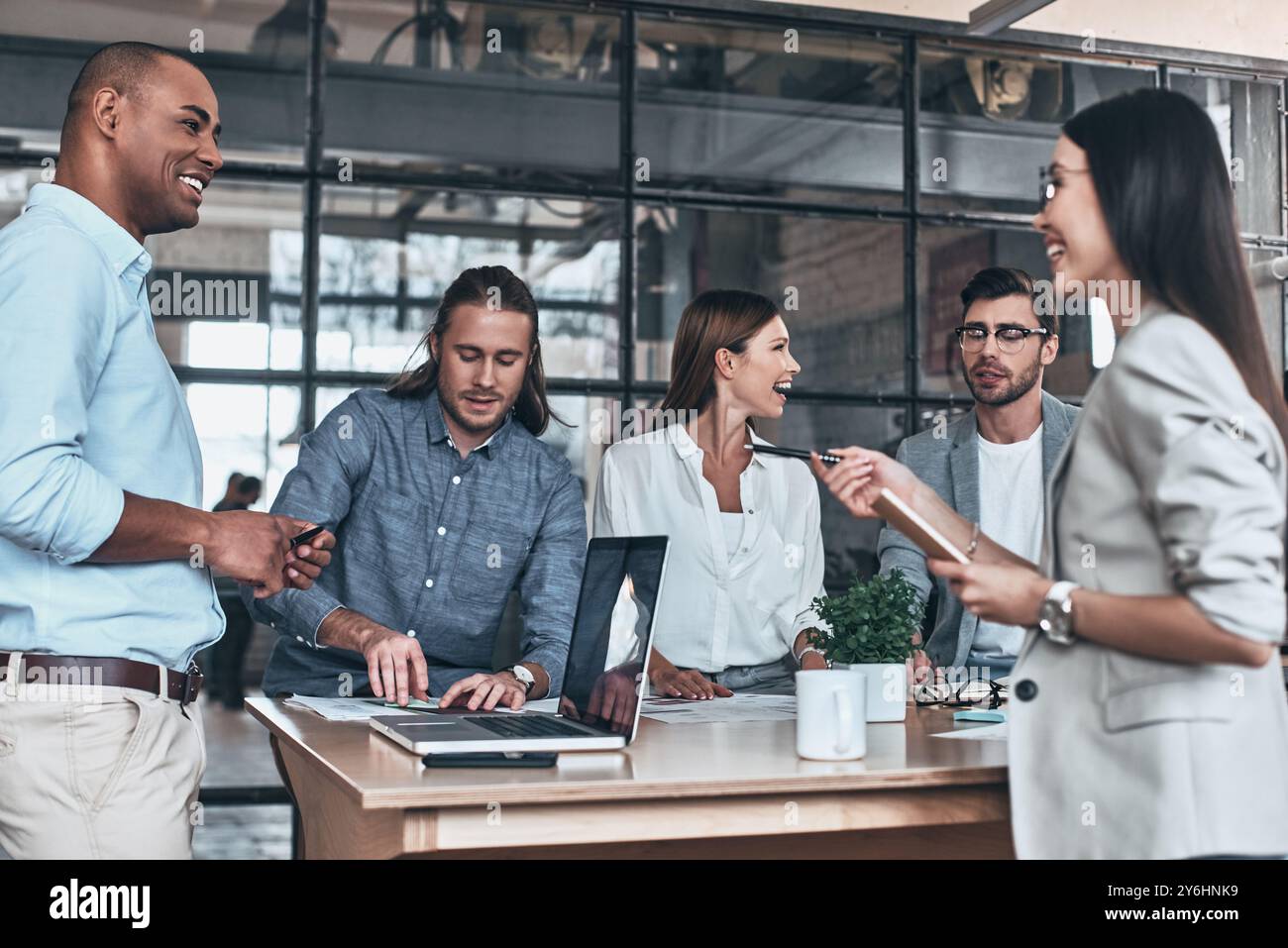 Mutual understanding. Group of young business people communicating and ...