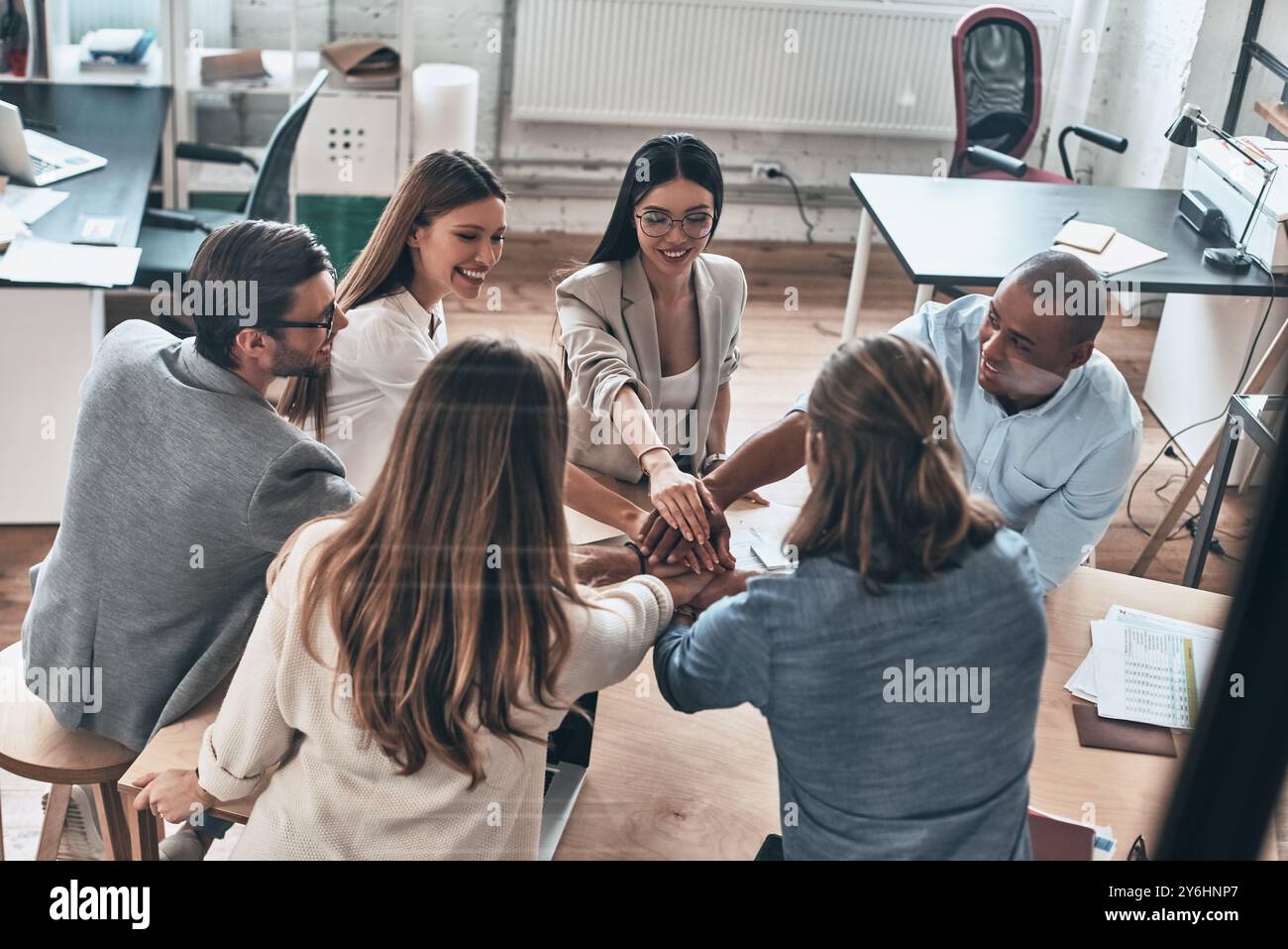 Inspired to work together. Top view of business colleagues holding ...