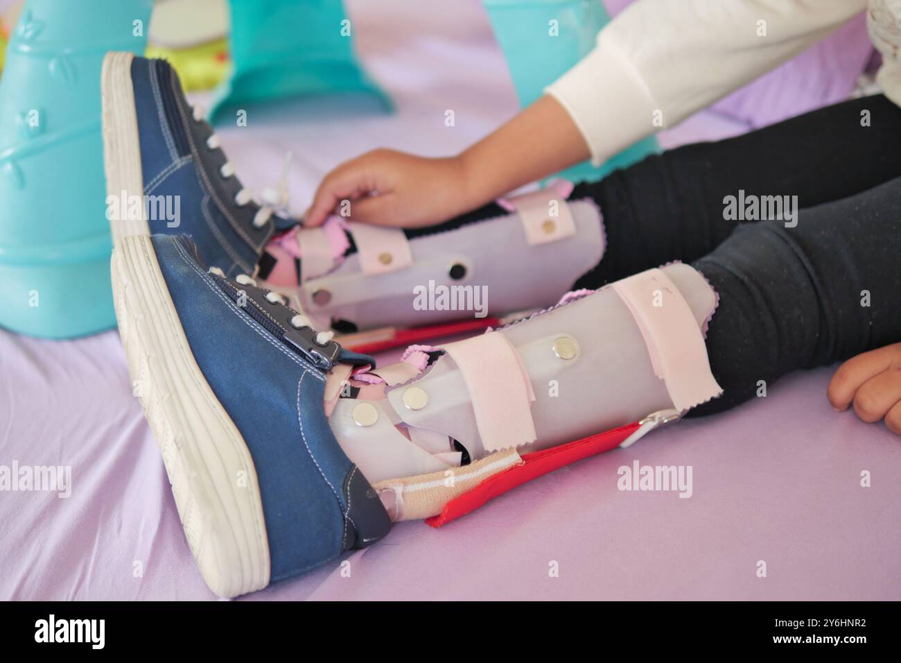 Child cerebral palsy disability, legs orthosis Stock Photo - Alamy