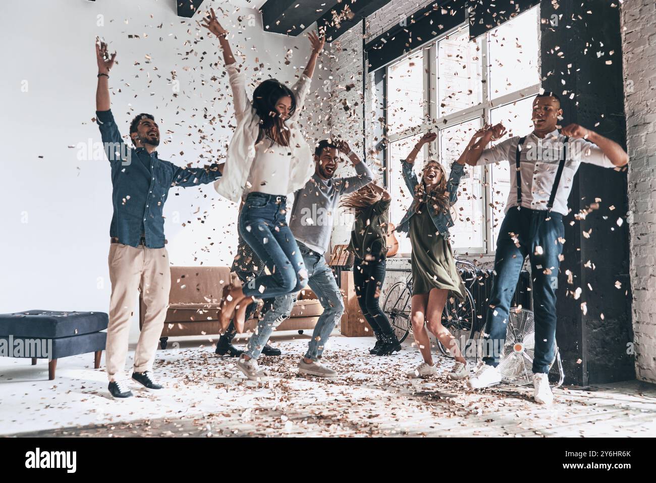 Hanging out together. Full length of happy young people dancing while ...