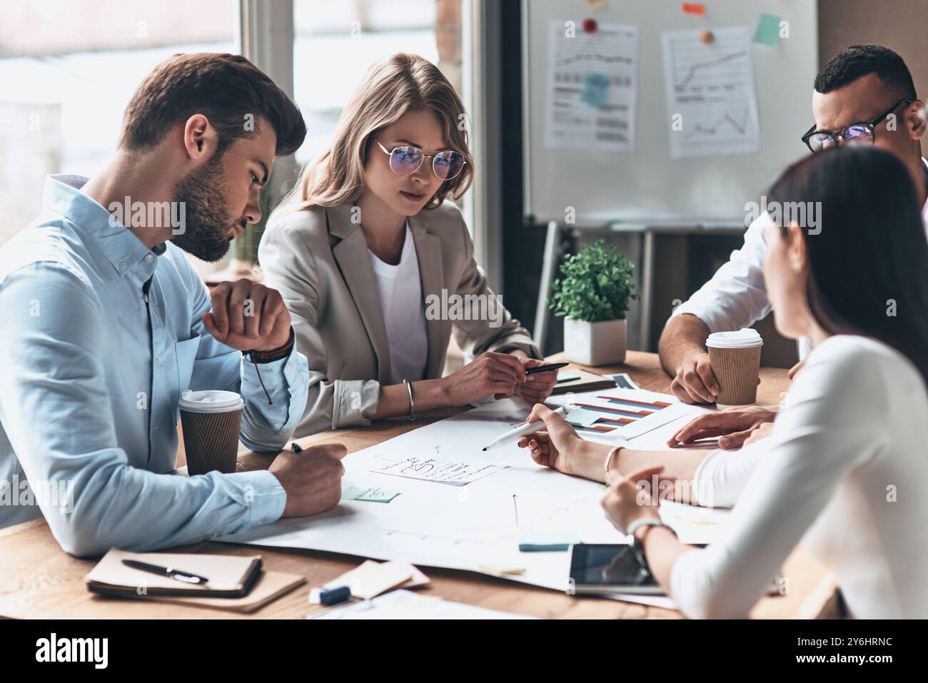 Daily meeting. Young modern people in smart casual wear working using ...