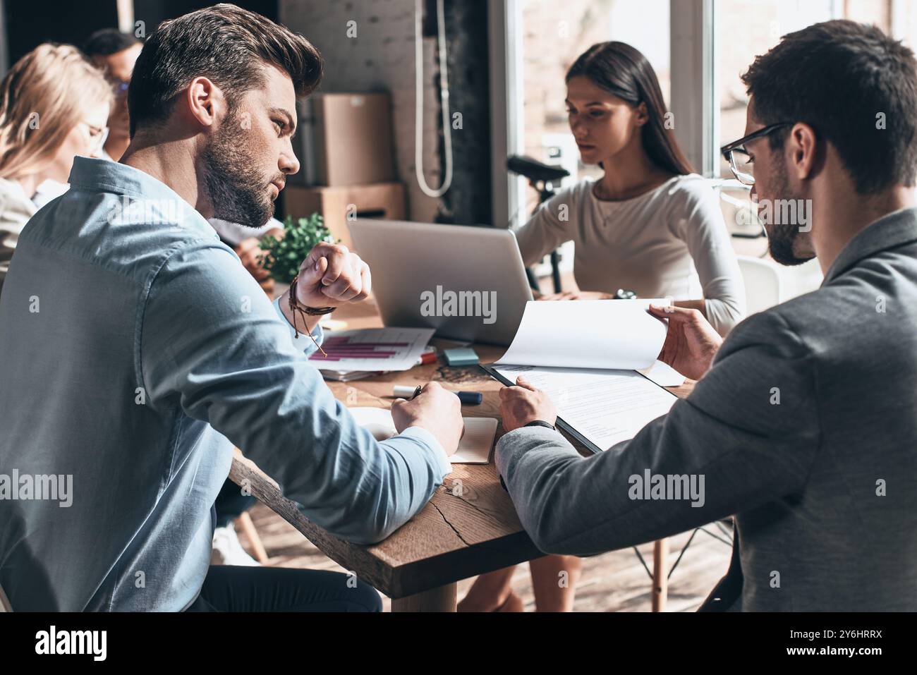 Hard working day. Young modern people in smart casual wear working ...