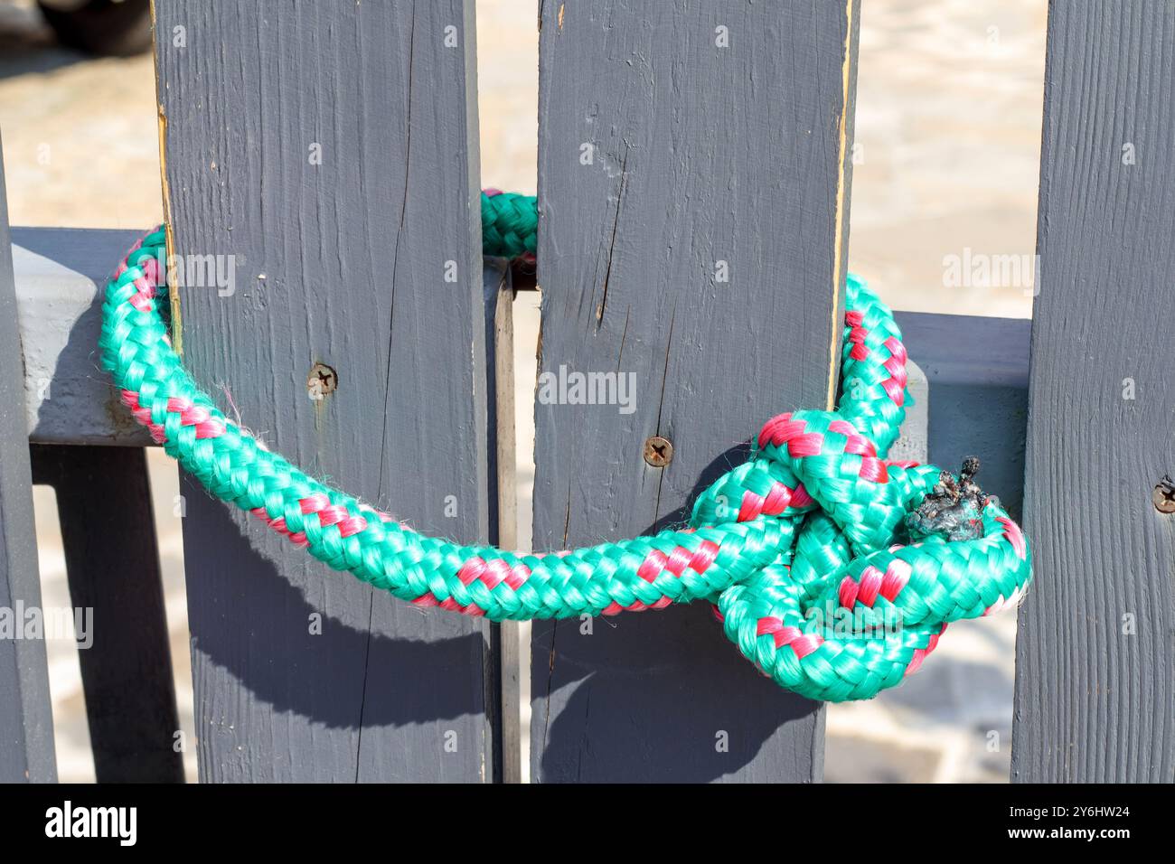 green string tied around the fence Stock Photo - Alamy
