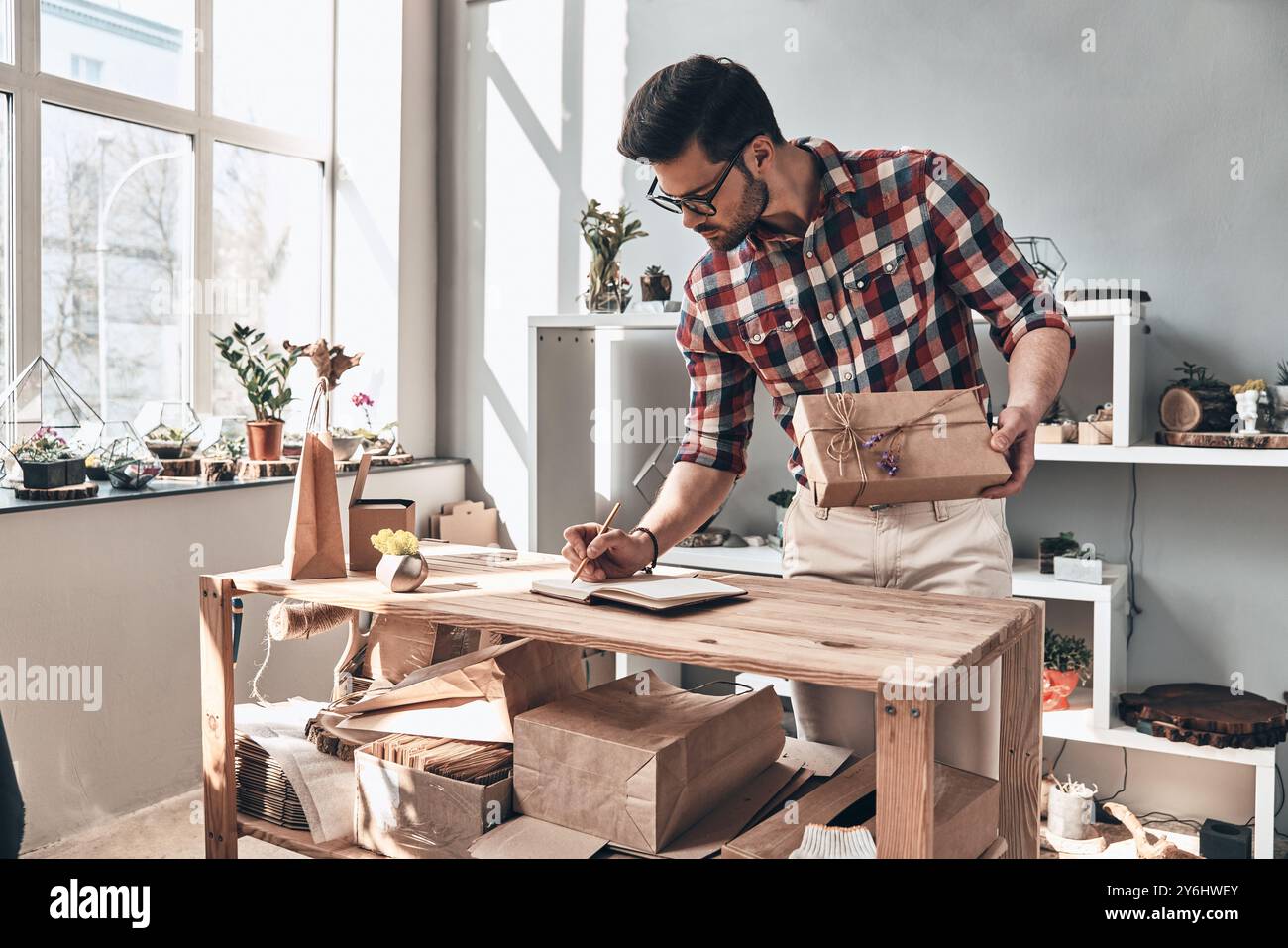 And this one goes to... Handsome young man writing something down in ...