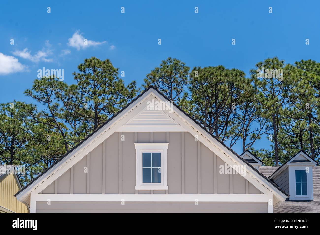Gable with grey horizontal vinyl lap siding, double hung window with ...