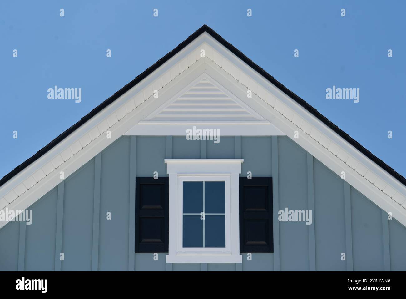 Gable with grey horizontal vinyl lap siding, double hung window with ...