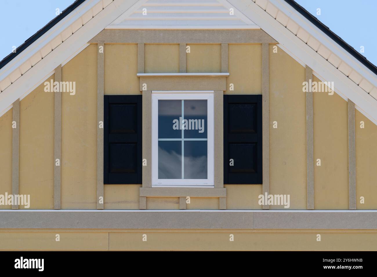 Under construction yellow garage gable roof with decorative window with ...