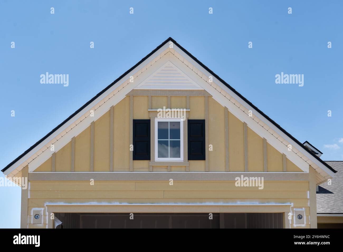 Under construction yellow garage gable roof with decorative window with ...