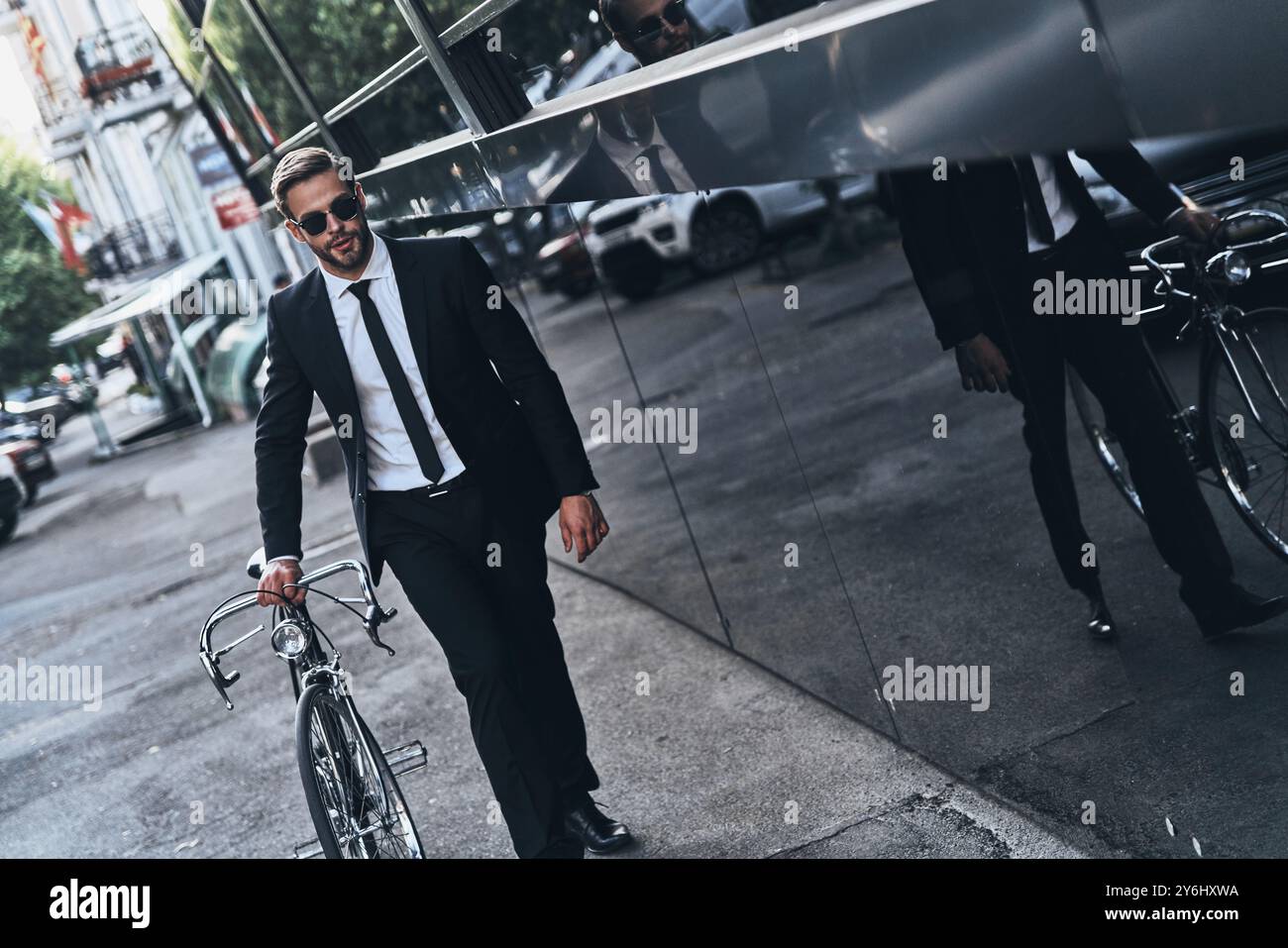Environmental friendly. Handsome young man in full suit pulling his ...