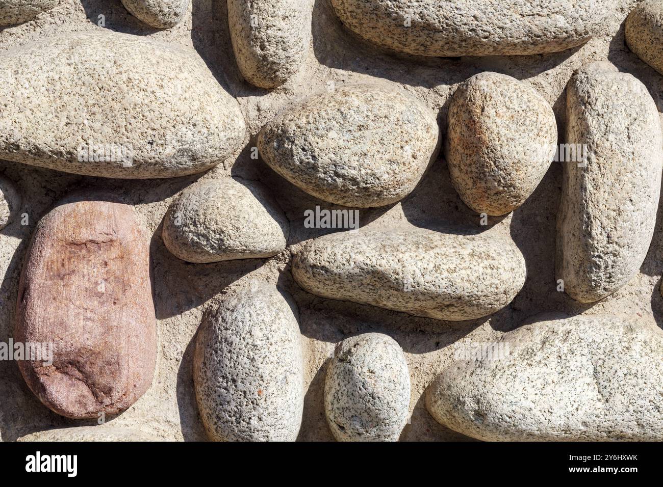 Wall background of various round stones Stock Photo - Alamy