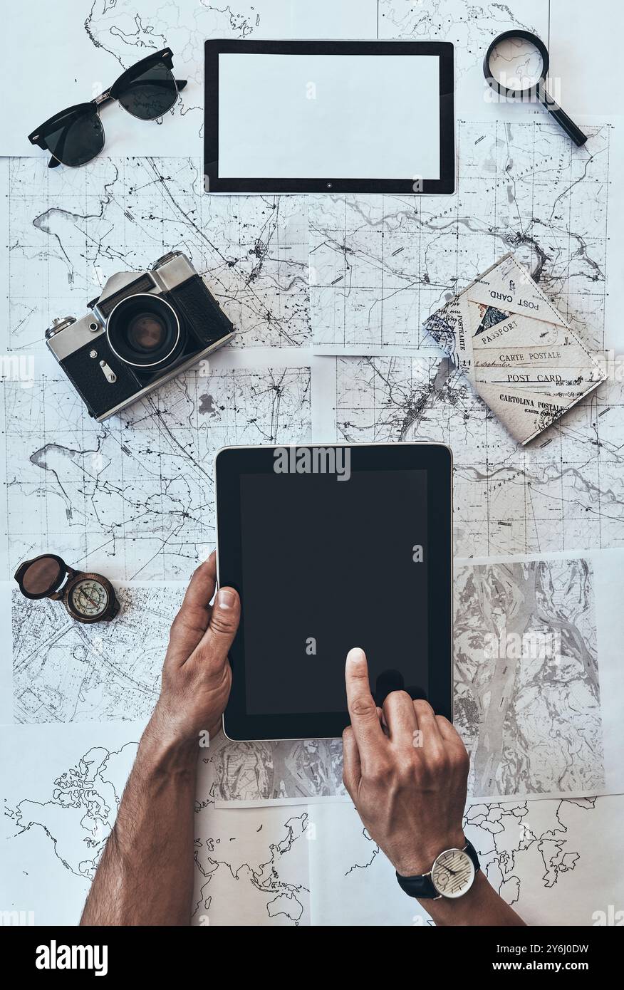 Planning journey. Close up top view of man using digital tablet with ...