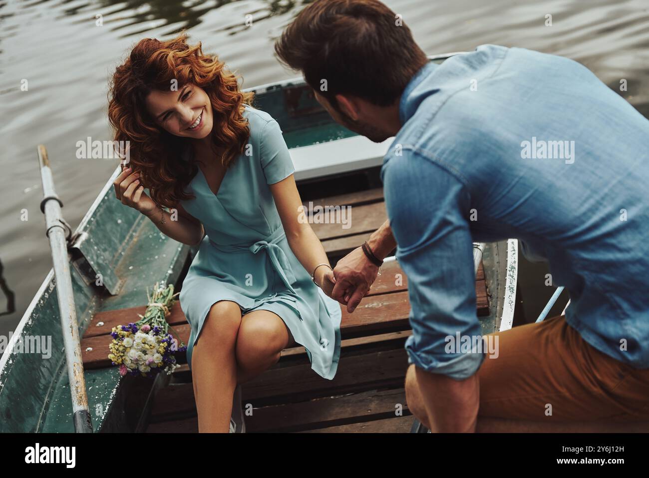 Best date ever. Happy young couple getting ready to row a boat while ...
