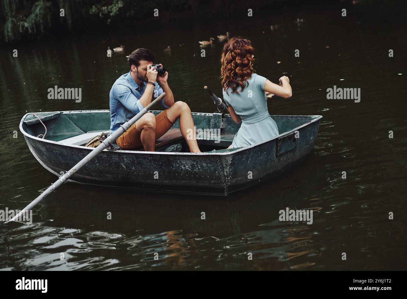 Nice shot. Young man photographing his beautiful girlfriend while ...