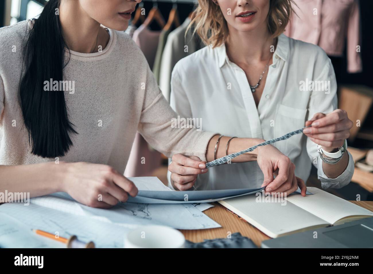 Working on trending designs. Close up young women working on swatches ...